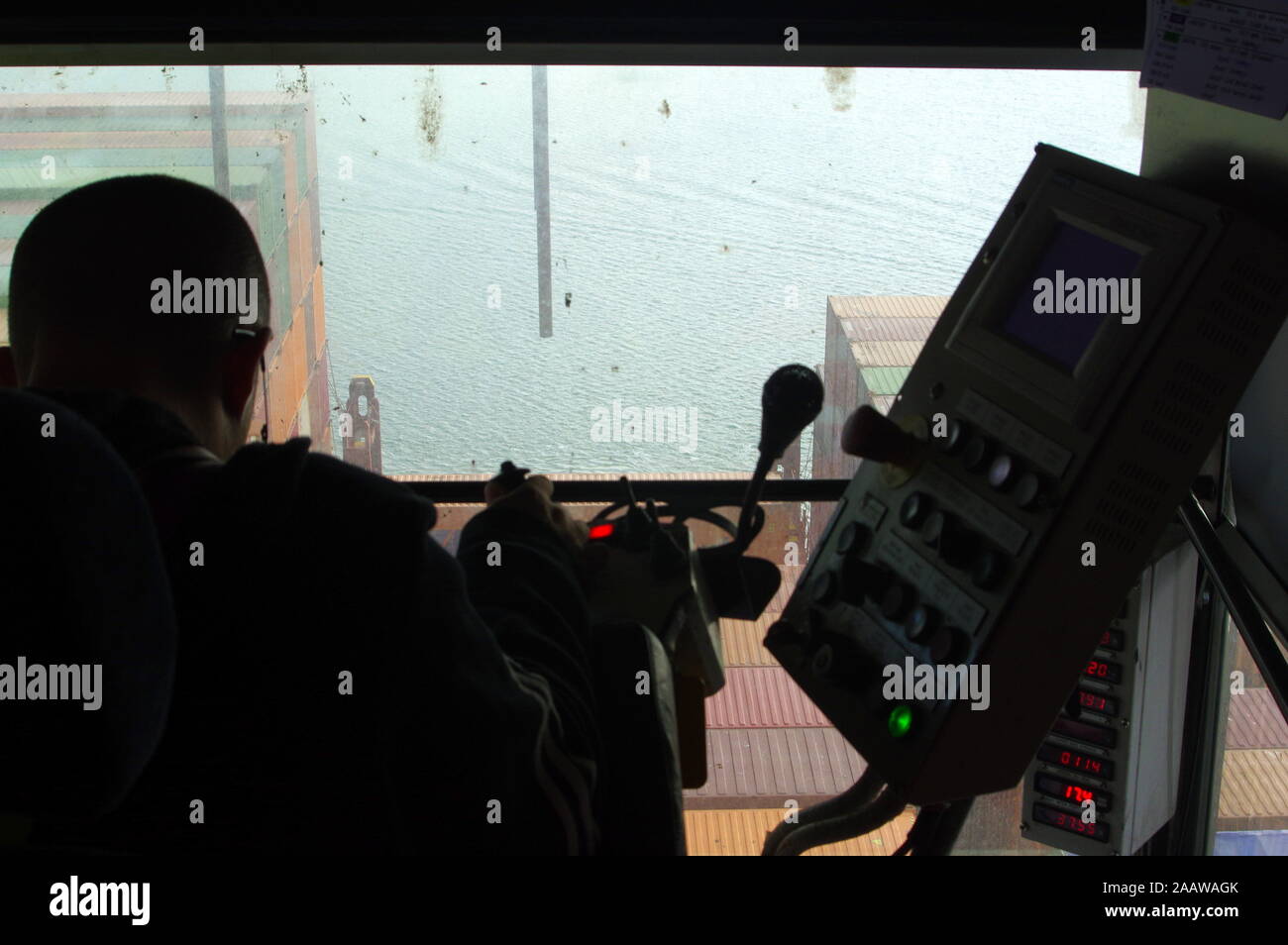 Gantry crane operator moving a sea container in the Port Stock Photo ...
