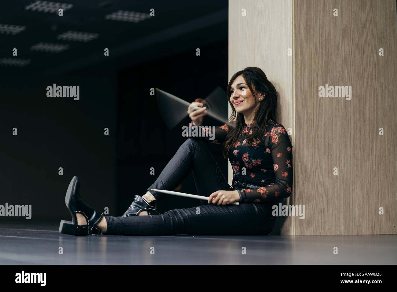 Smiling female drummer rotating a drum stick Stock Photo - Alamy