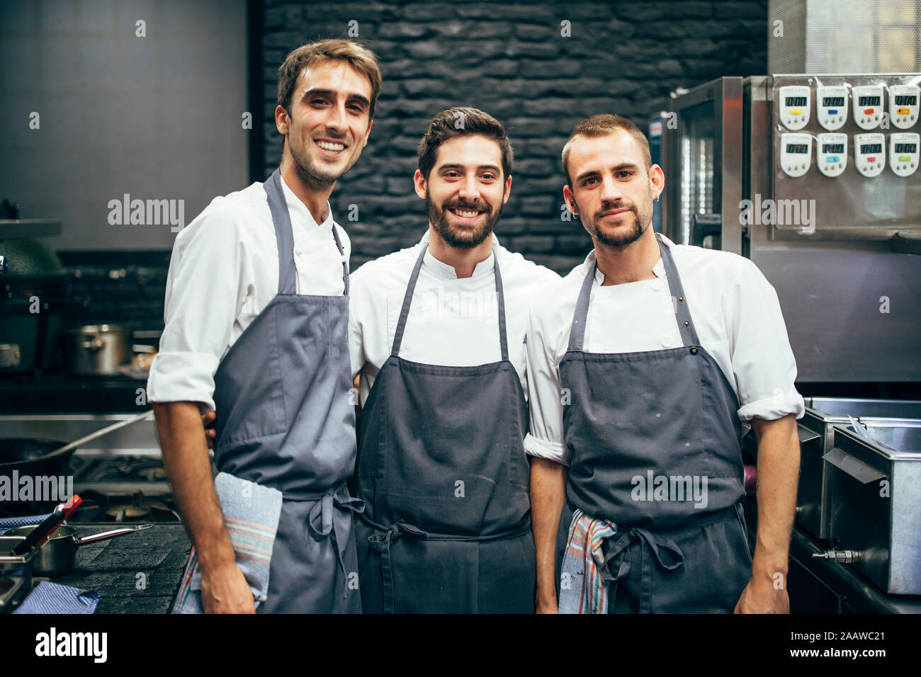 Portrait of three cooks in the kitchen of a restaurant Stock Photo - Alamy