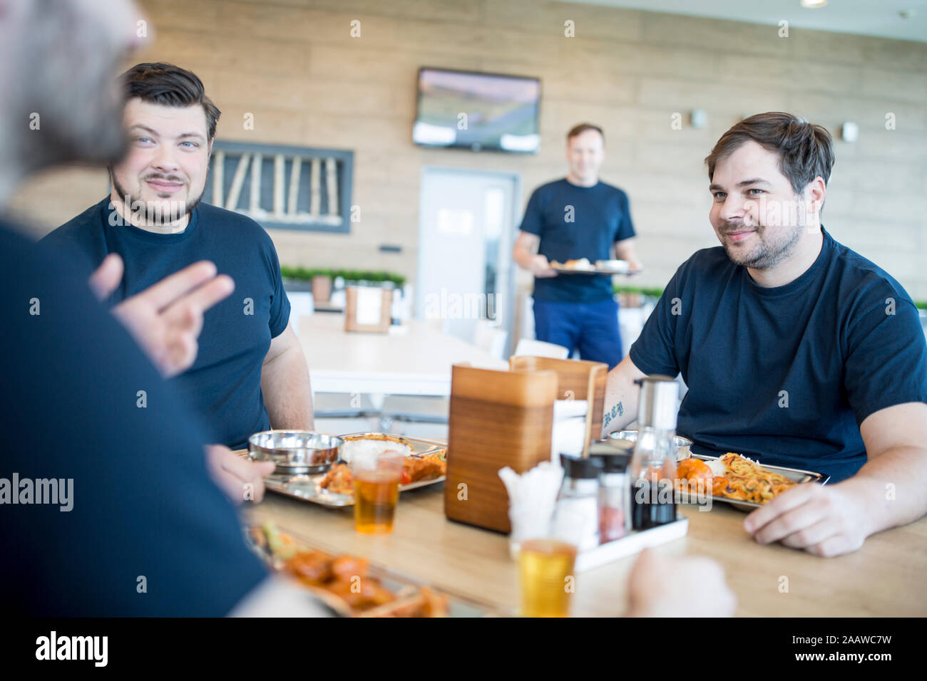 Colleagues having lunch break in canteen Stock Photo - Alamy