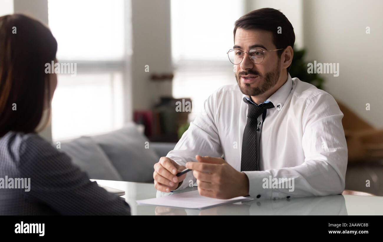 Male consultant talking with female customer at office meeting Stock ...