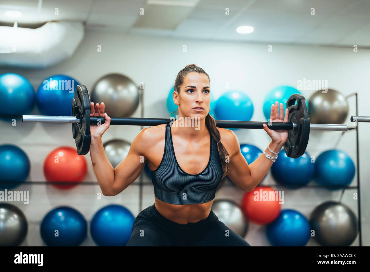 Woman exercising with weight in a gym Stock Photo - Alamy