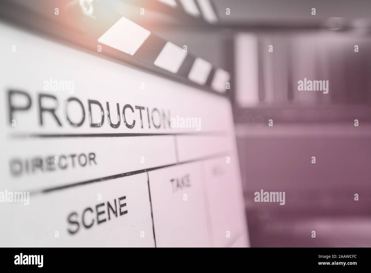 Movie clapper and editing room in background Stock Photo - Alamy