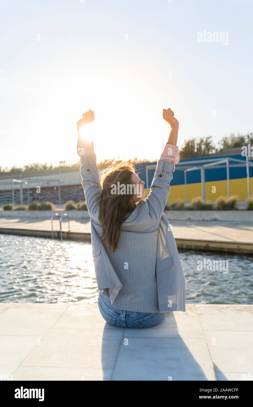 Back view of young woman stretching at backlight Stock Photo - Alamy