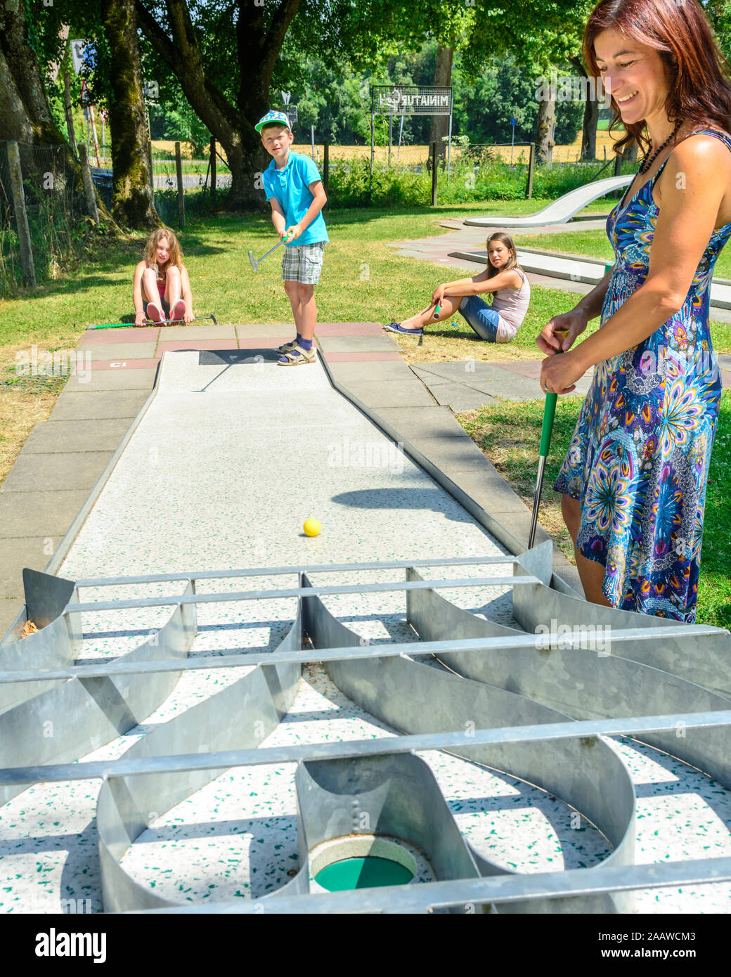 Funny afternoon with the Kids on a minigolf course Stock Photo - Alamy