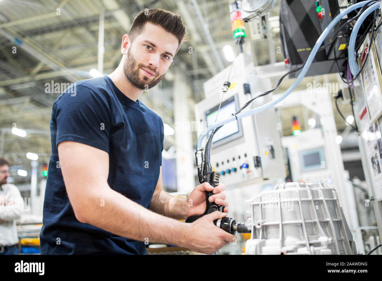 Portrait of a confident man working in a modern factory Stock Photo - Alamy