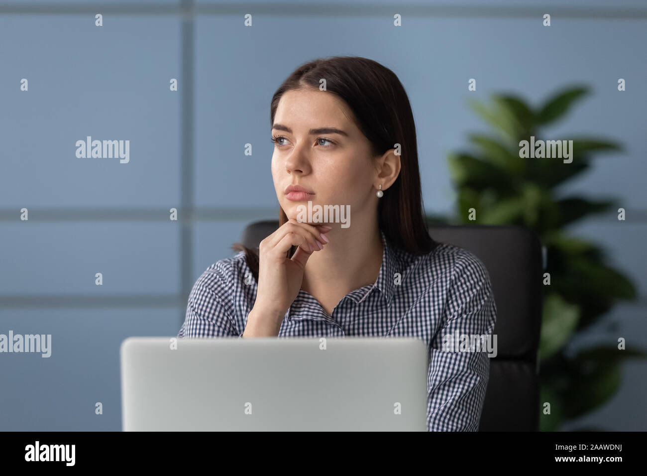 Pensive female employee look in distance thinking Stock Photo - Alamy