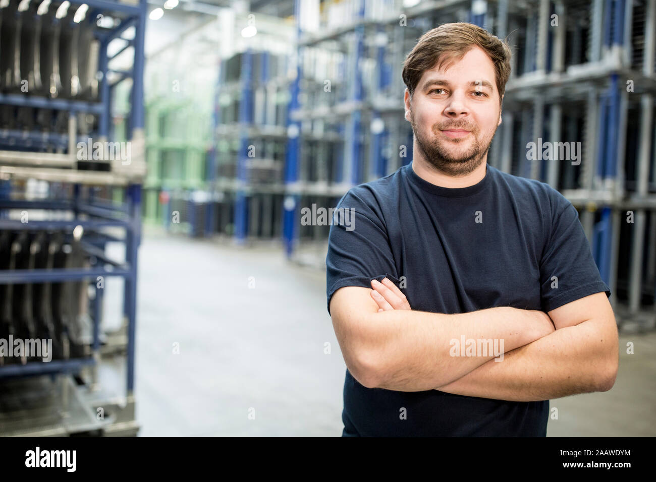 Portrait of confident worker in a factory warehouse Stock Photo - Alamy