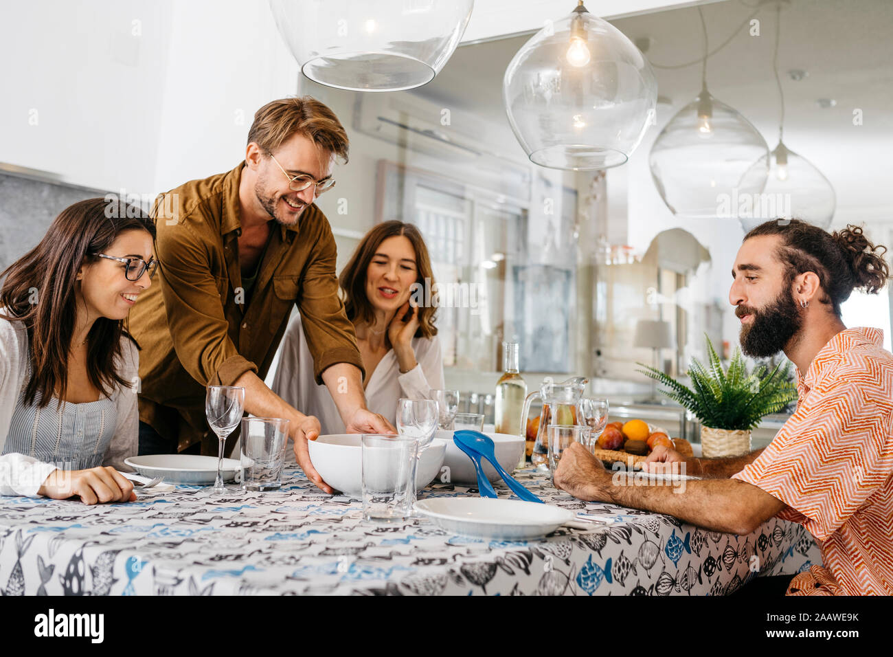 Happy friends having lunch together Stock Photo - Alamy