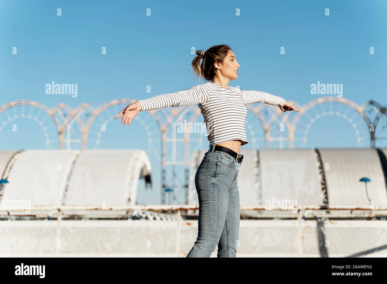 Young blond woman balancing Stock Photo - Alamy