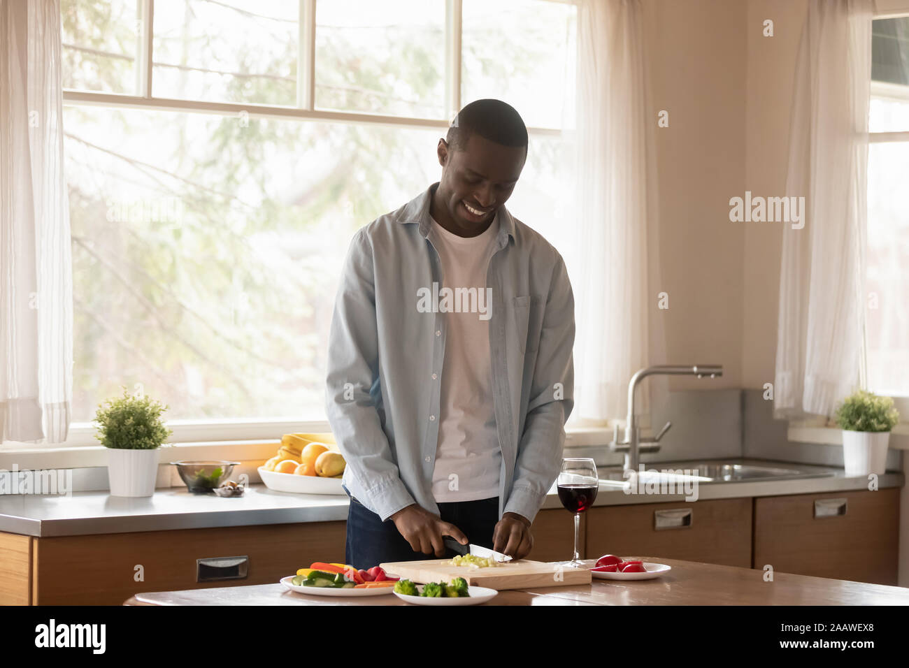 African American man cooking in modern kitchen Stock Photo - Alamy