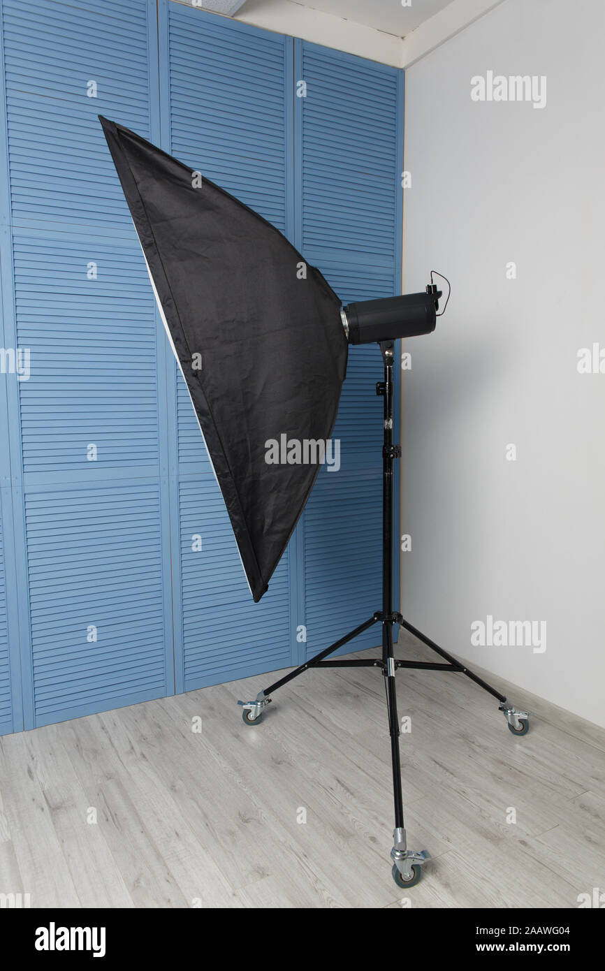 Studio flash with soft box standing in the corner of the Studio. Side ...