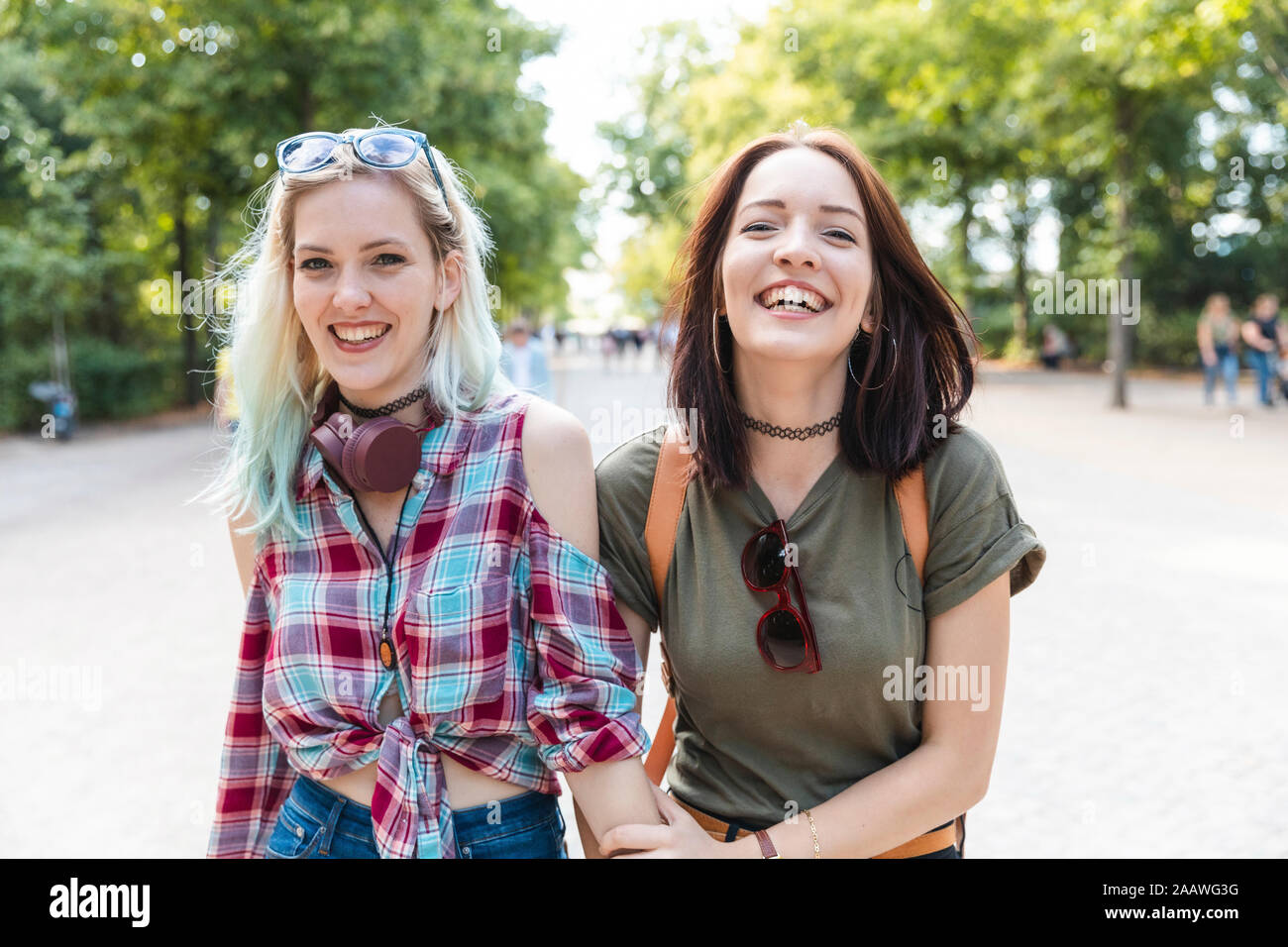 Portrait of two happy friends together in a park Stock Photo - Alamy