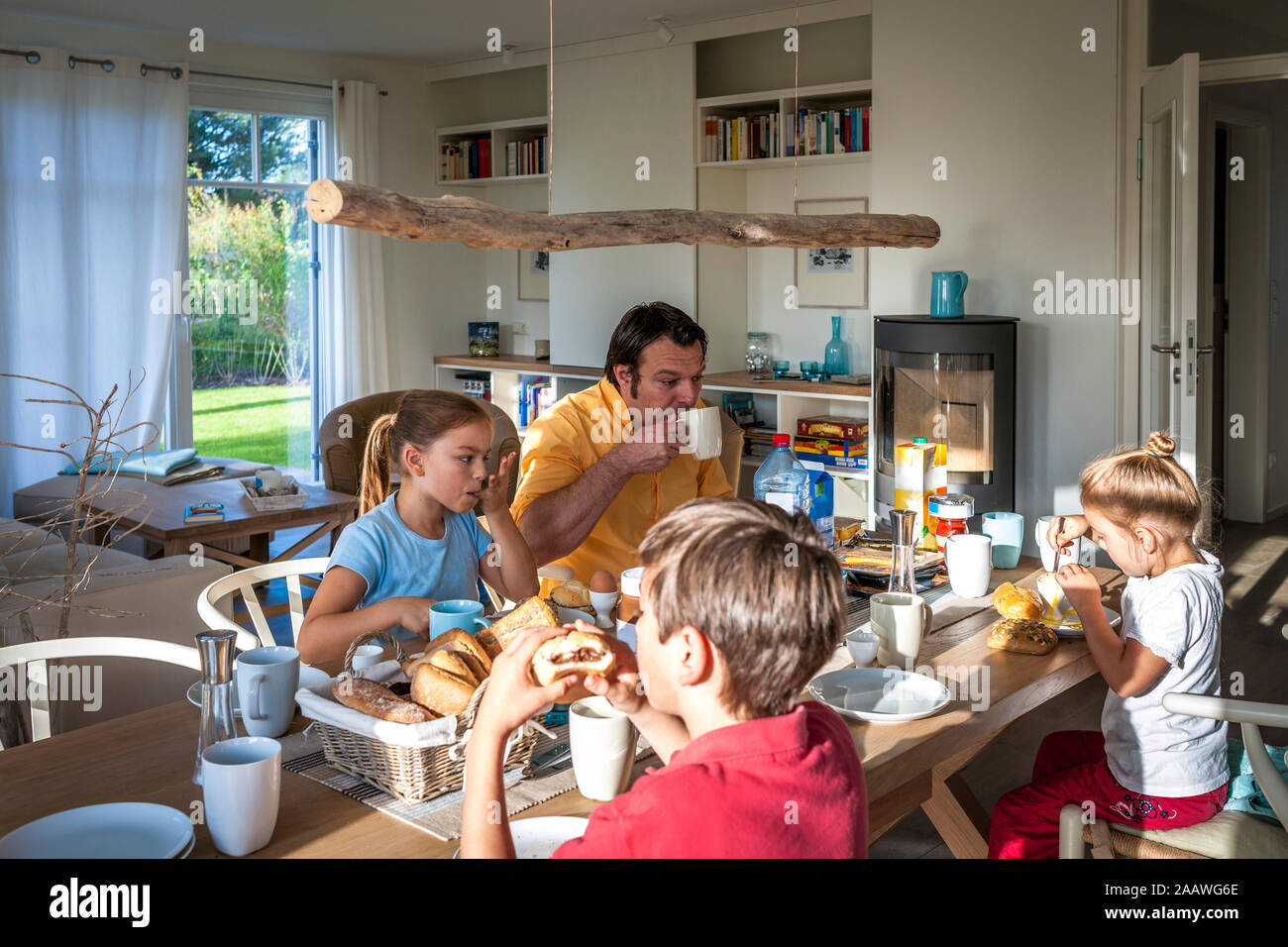 Family having breakfast at dining table Stock Photo - Alamy