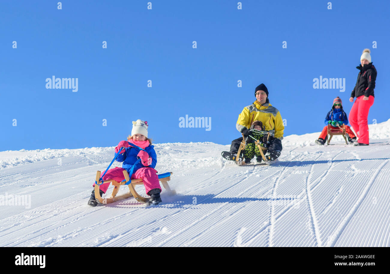 Funny afternoon in wintertime on sleigh slope Stock Photo - Alamy