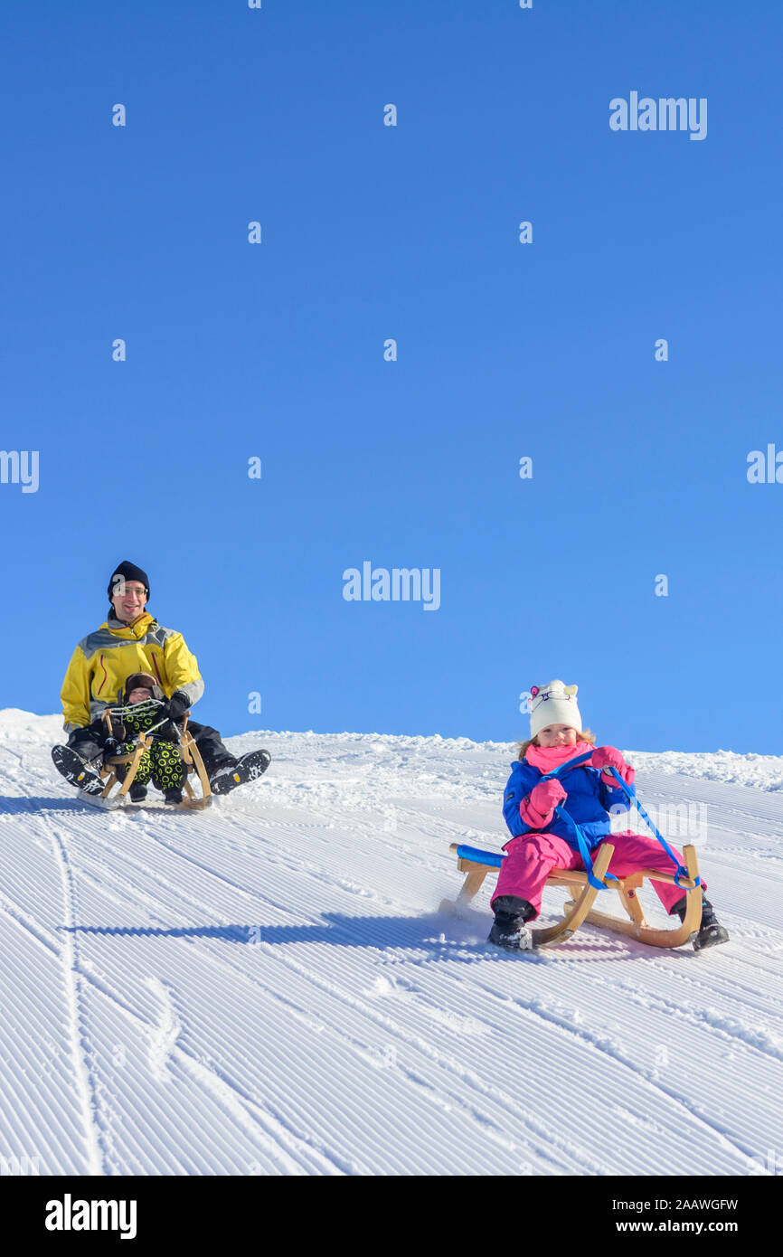 Funny afternoon in wintertime on sleigh slope Stock Photo - Alamy