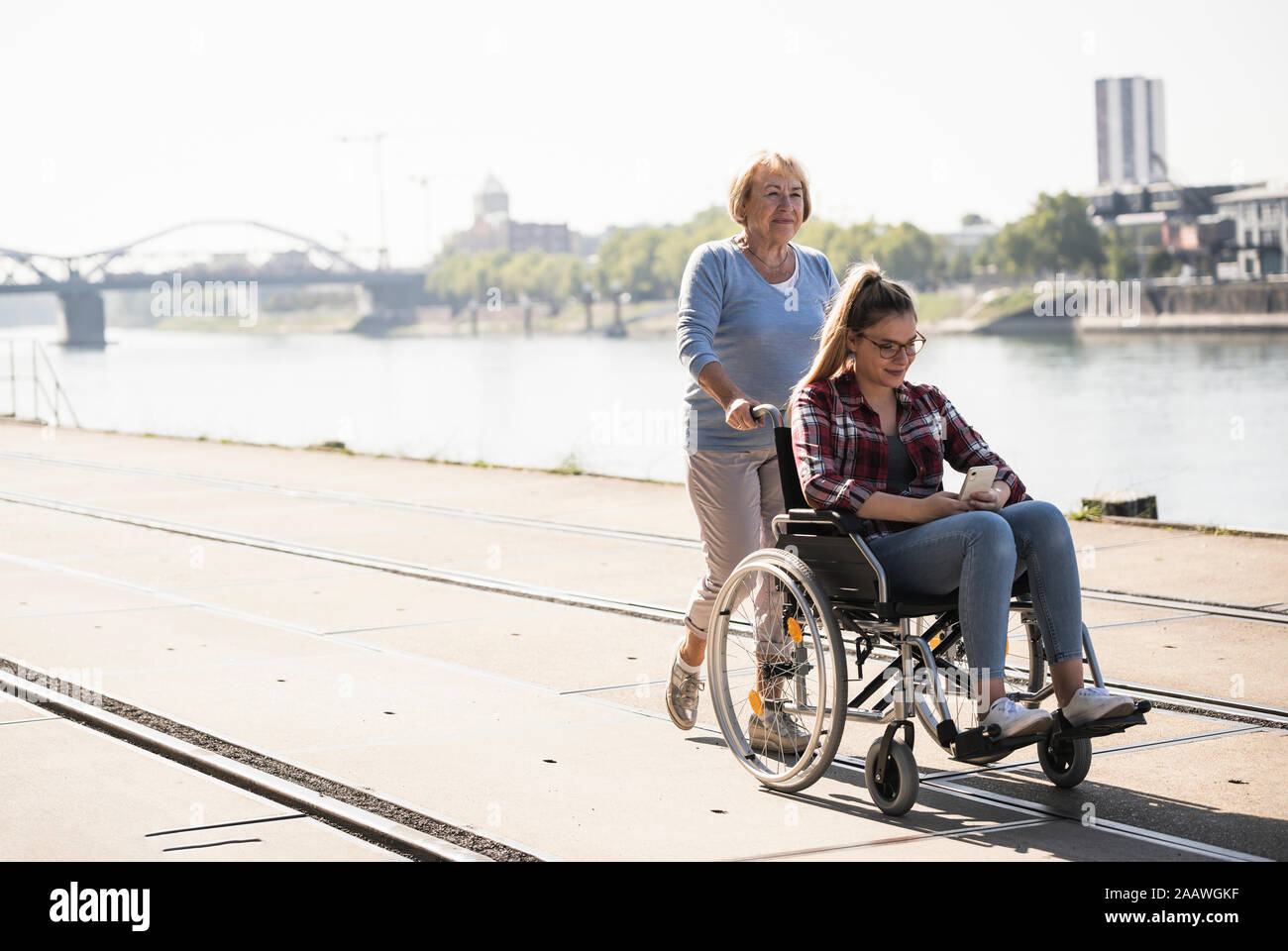 Grandmother with her granddaughter sitting in wheelchair Stock Photo ...