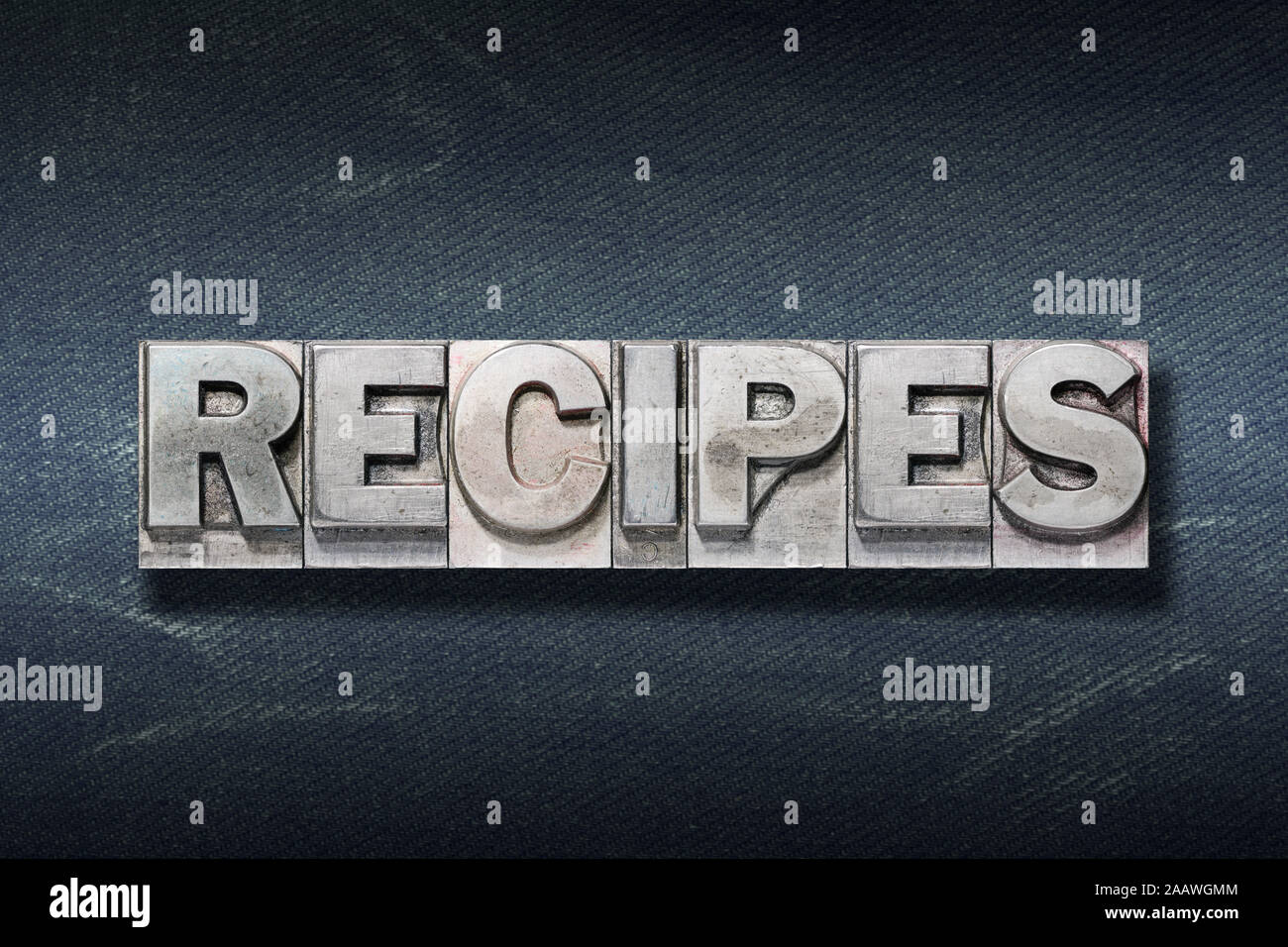 recipes word made from metallic letterpress on dark jeans background ...