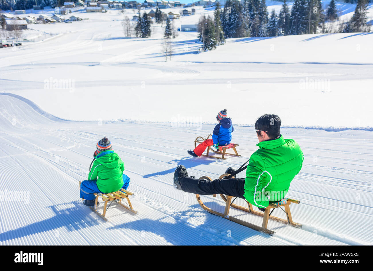 Funny afternoon in wintertime on sleigh slope Stock Photo - Alamy