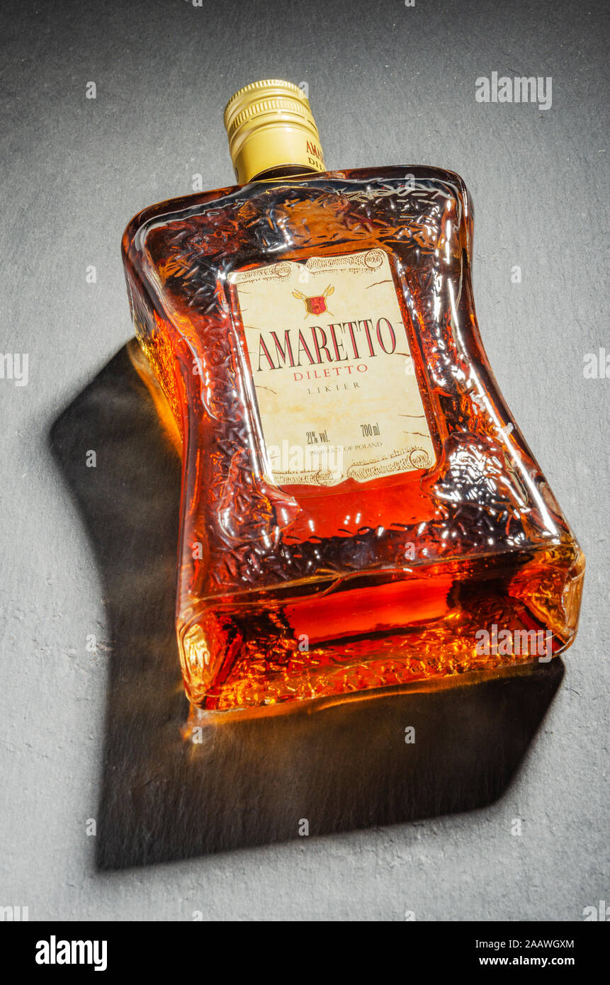 Bottle of Amaretto liqueur on stone slate background. Amaretto comes ...