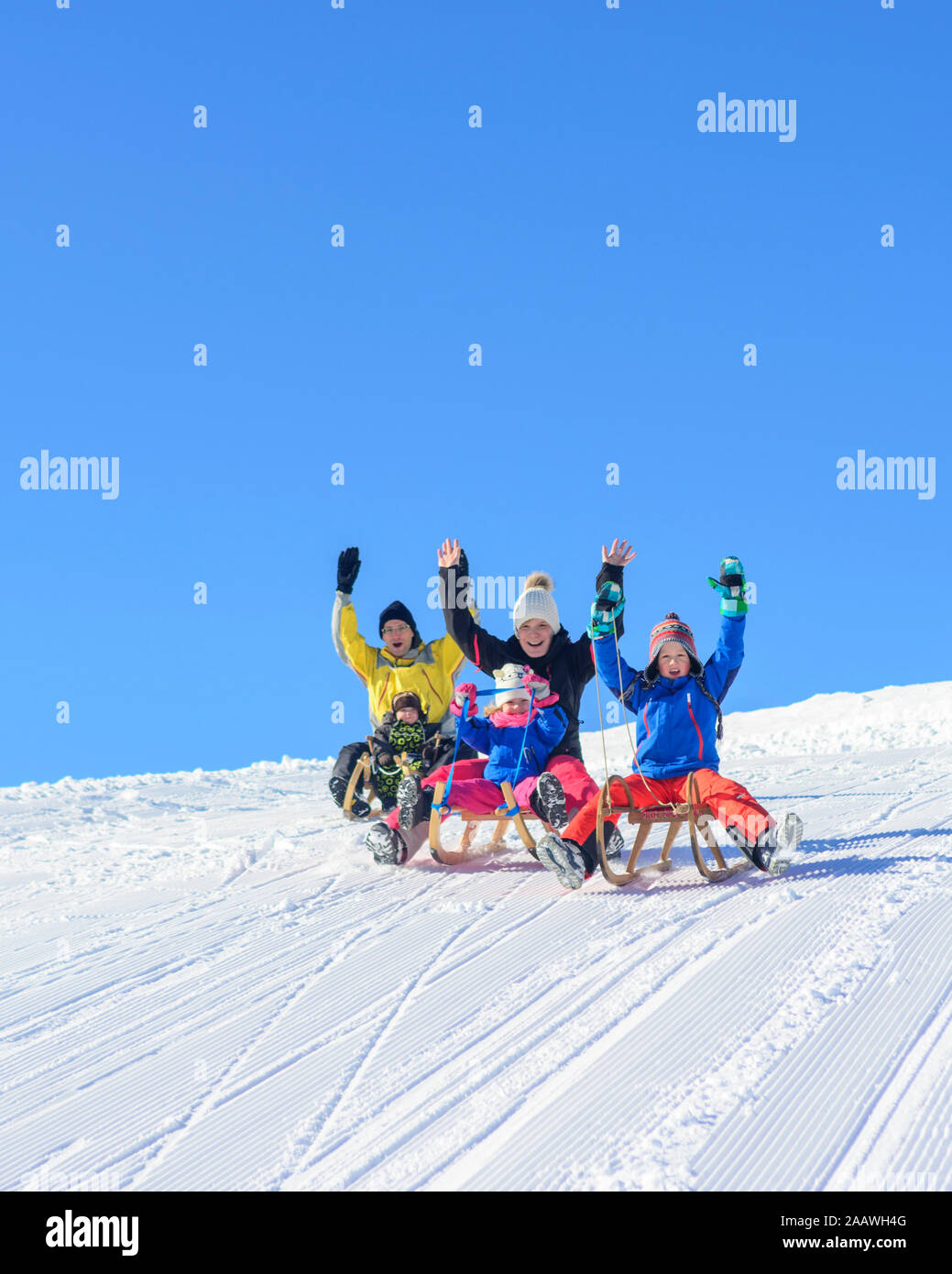 Funny afternoon in wintertime on sleigh slope Stock Photo - Alamy