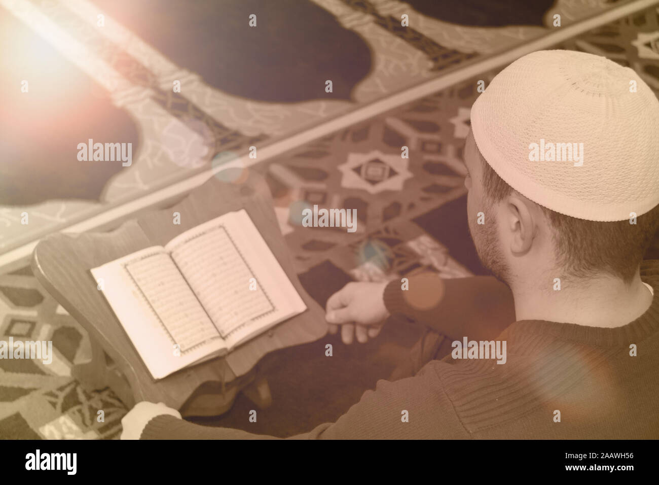 Muslim man reciting from holy book Koran, Qoran, islamic religious book ...