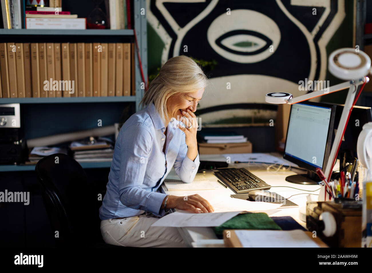 Mature woman working in architct's office, checking floor plans Stock ...
