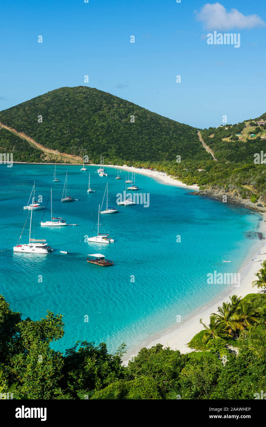 Aerial view of boats moored at Jost Van Dyke Island against blue sky ...