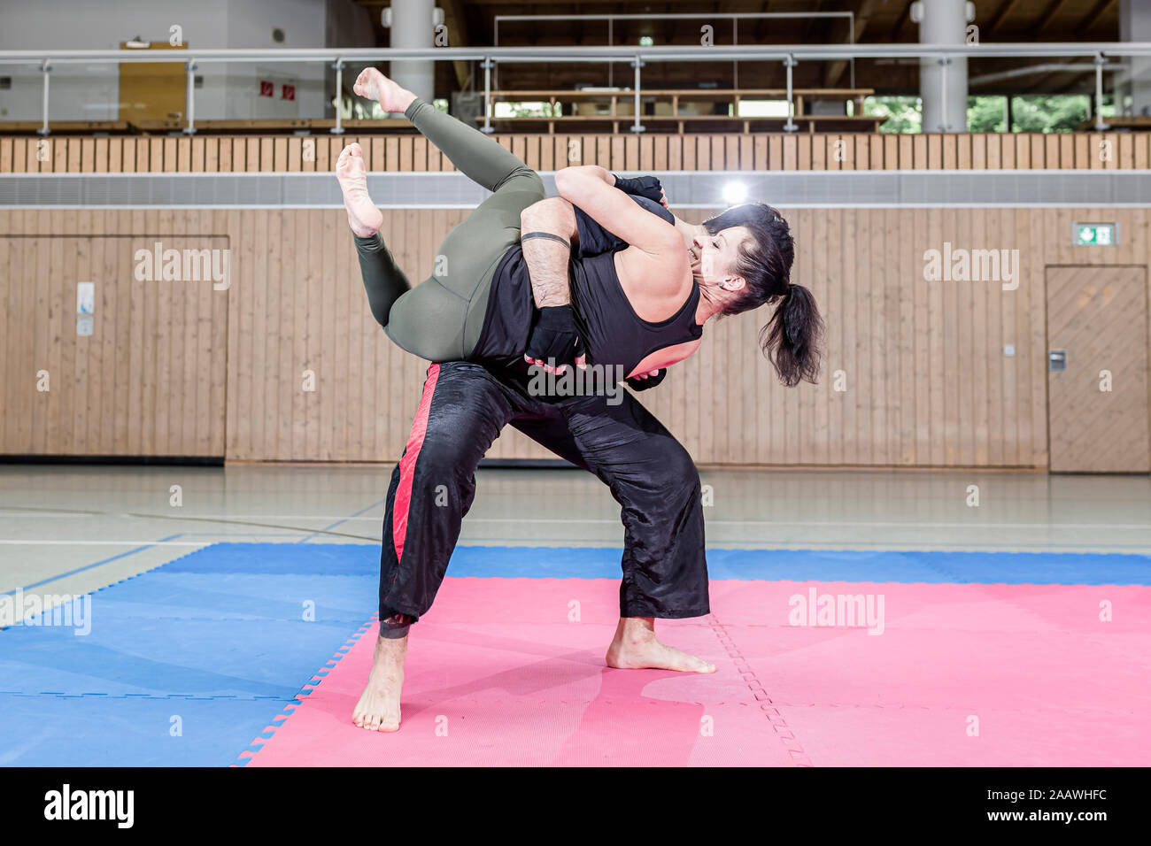 Female kickboxer practising with coach in sports hall Stock Photo - Alamy
