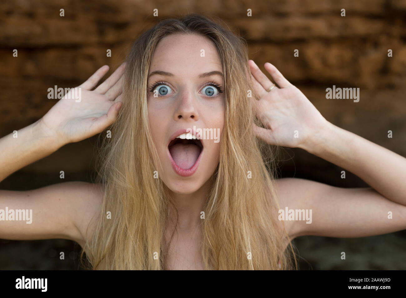 Portrait of screaming young woman raising hands Stock Photo - Alamy