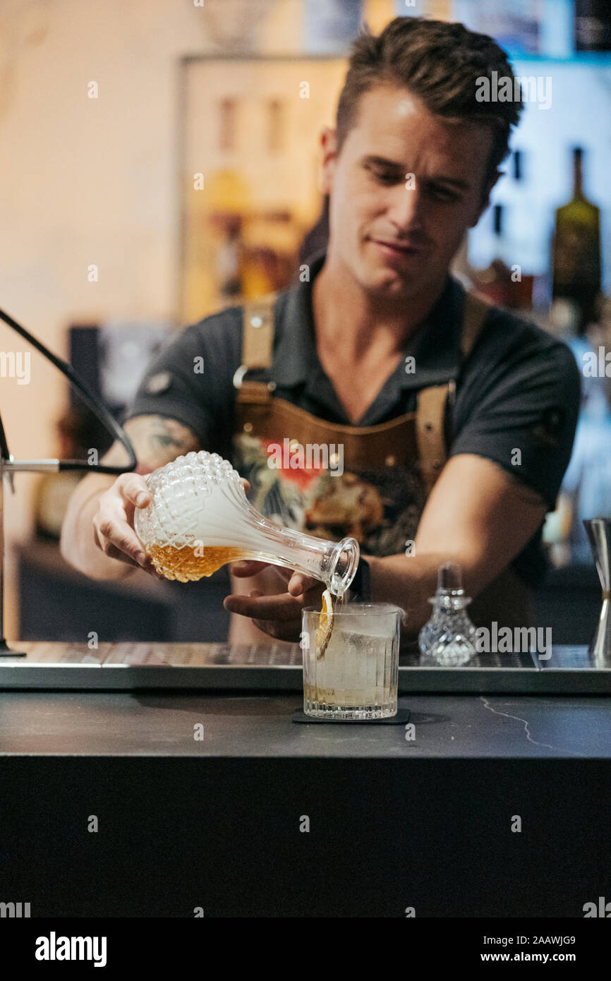 Bartender mixing cocktail in a bar, decanter with steam Stock Photo - Alamy