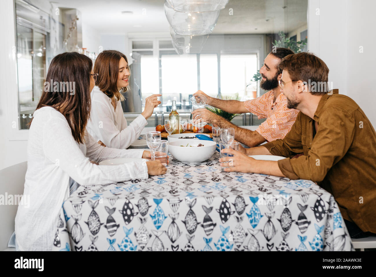 Happy friends having lunch together Stock Photo - Alamy