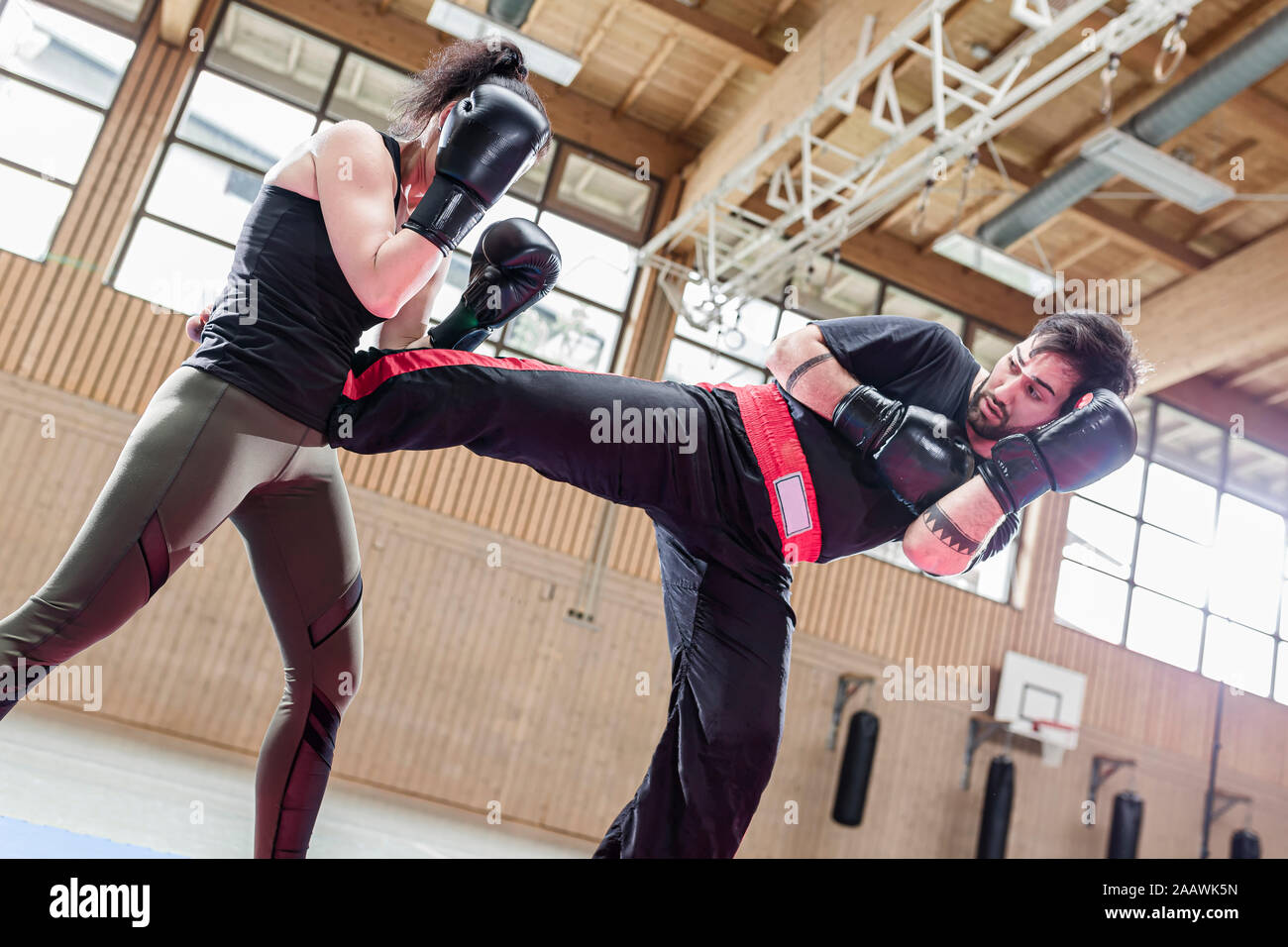 Female kickboxer sparring with coach in sports hall Stock Photo - Alamy