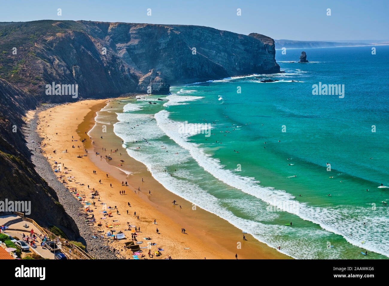 Portugal, Algarve, Arrifana, People relaxing along sandy coastal beach ...