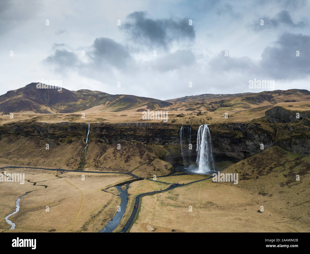 Iceland, Aerial view of waterfall splashing down high cliff Stock Photo ...