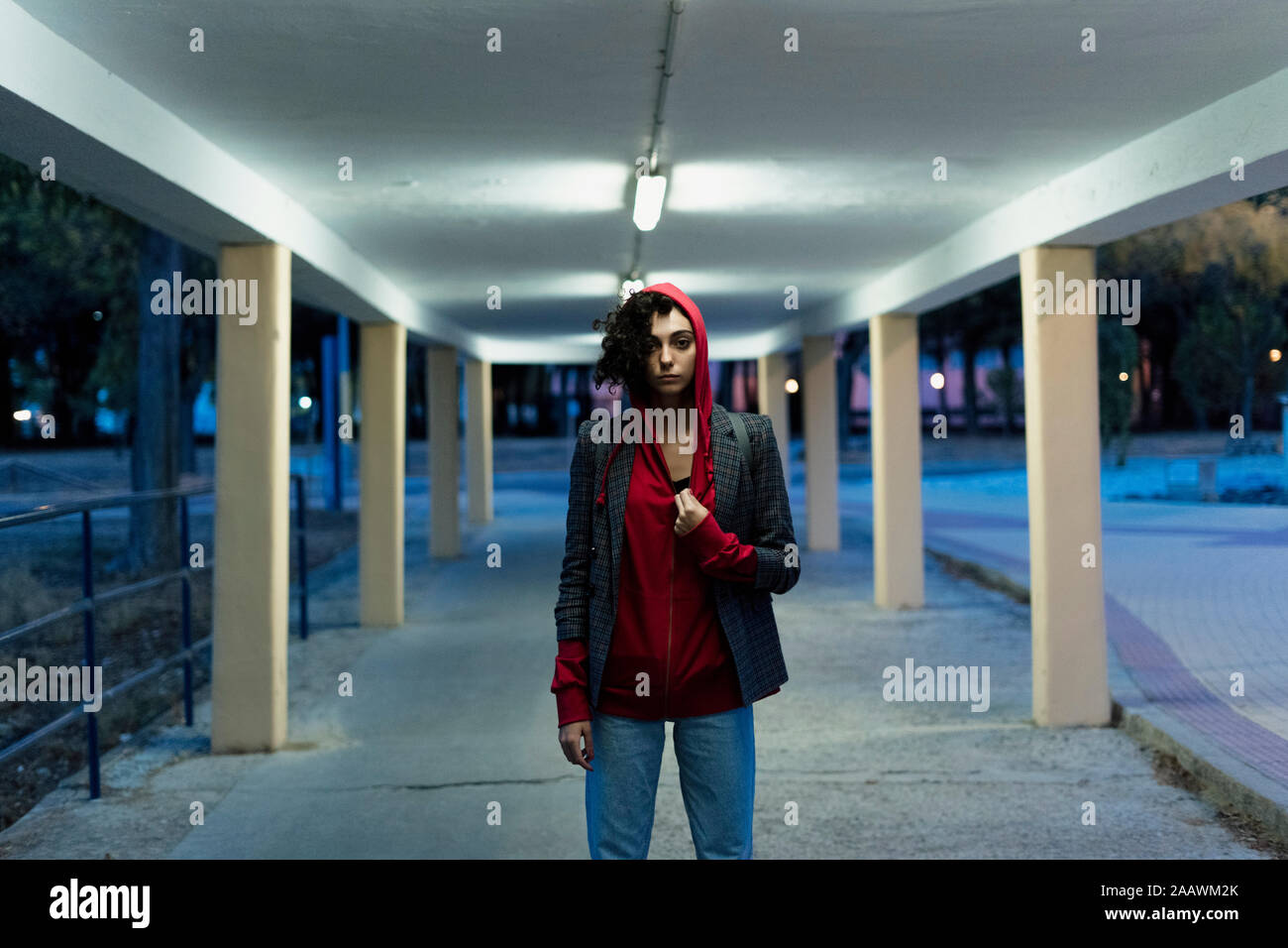 Portrait young woman wearing red hooded jacket evening light hi-res ...