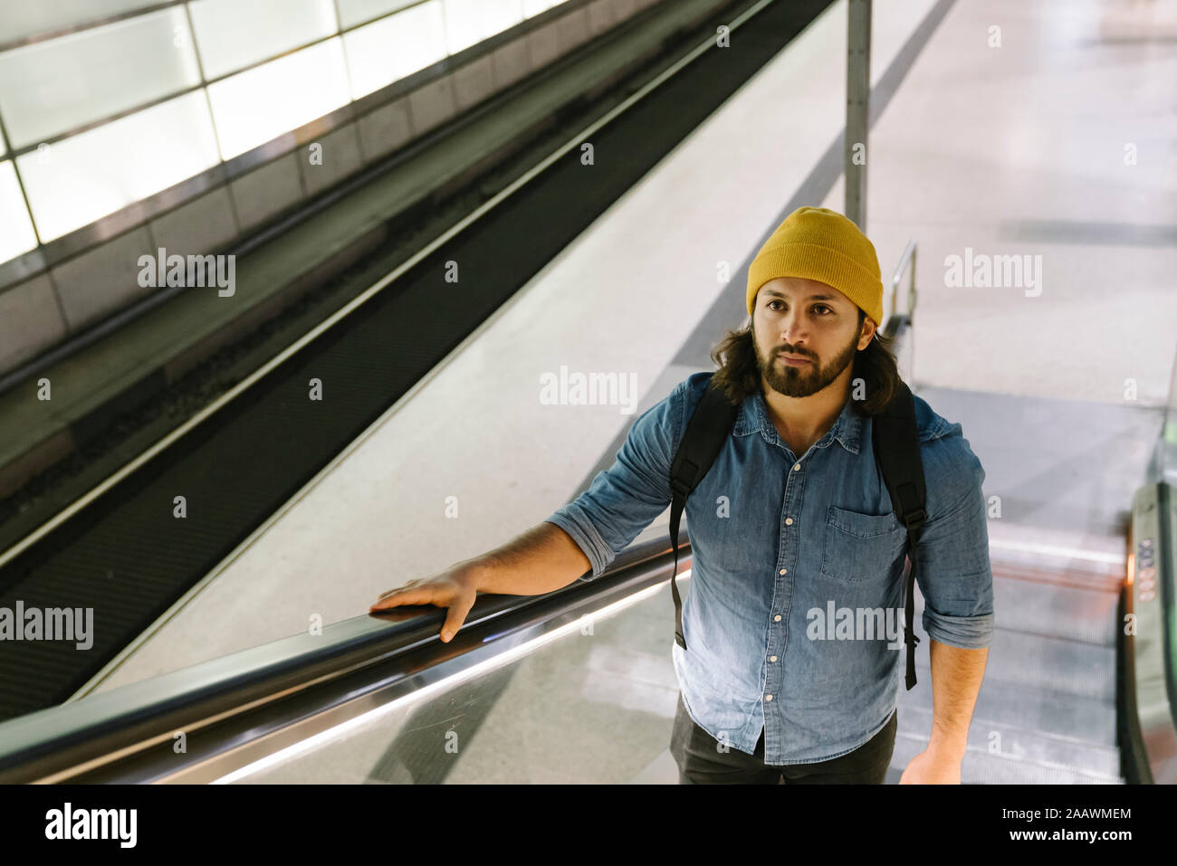 Portrait of man standing on escalator Stock Photo - Alamy