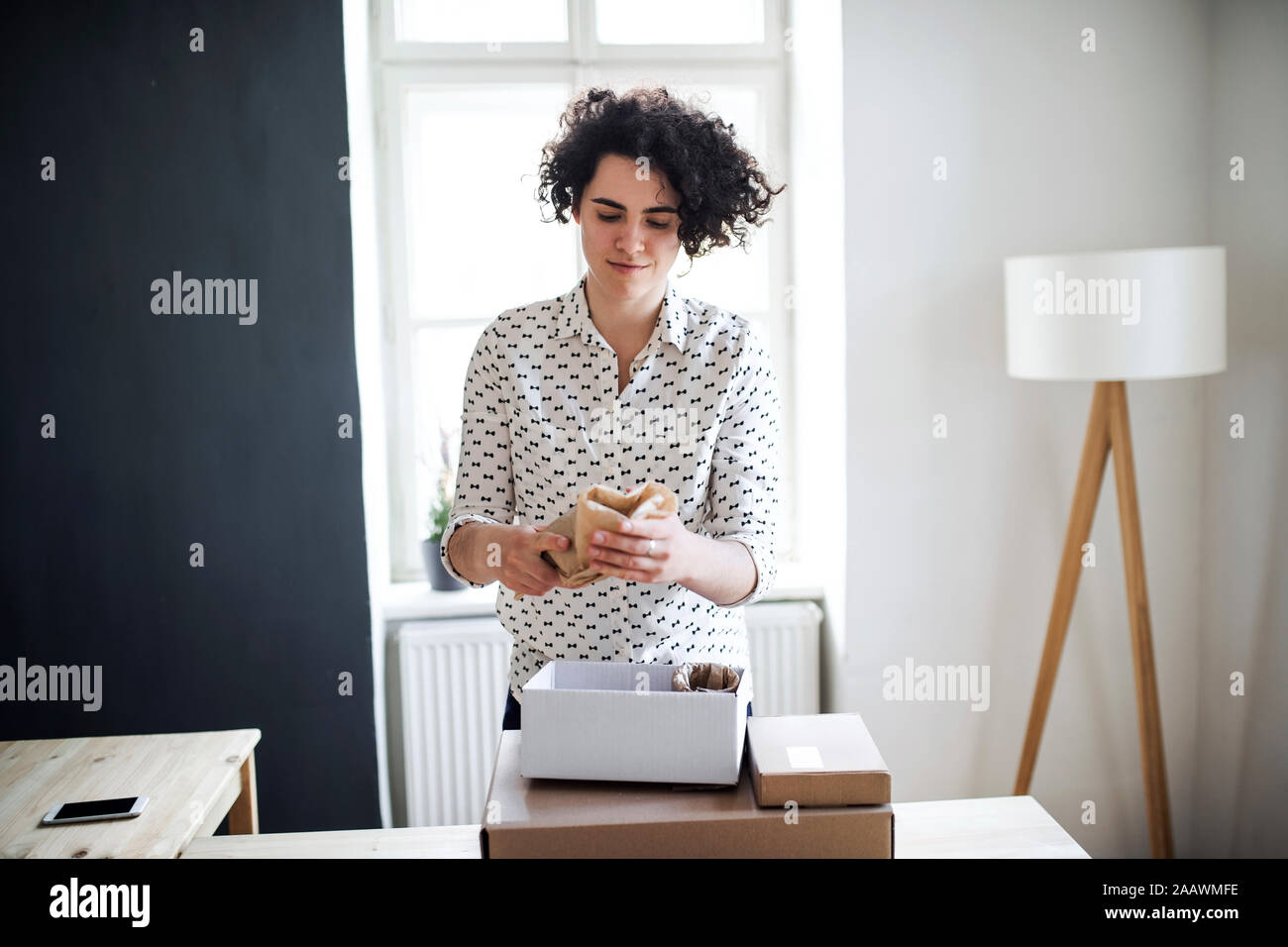 Wrapping a parcel woman hi-res stock photography and images - Alamy