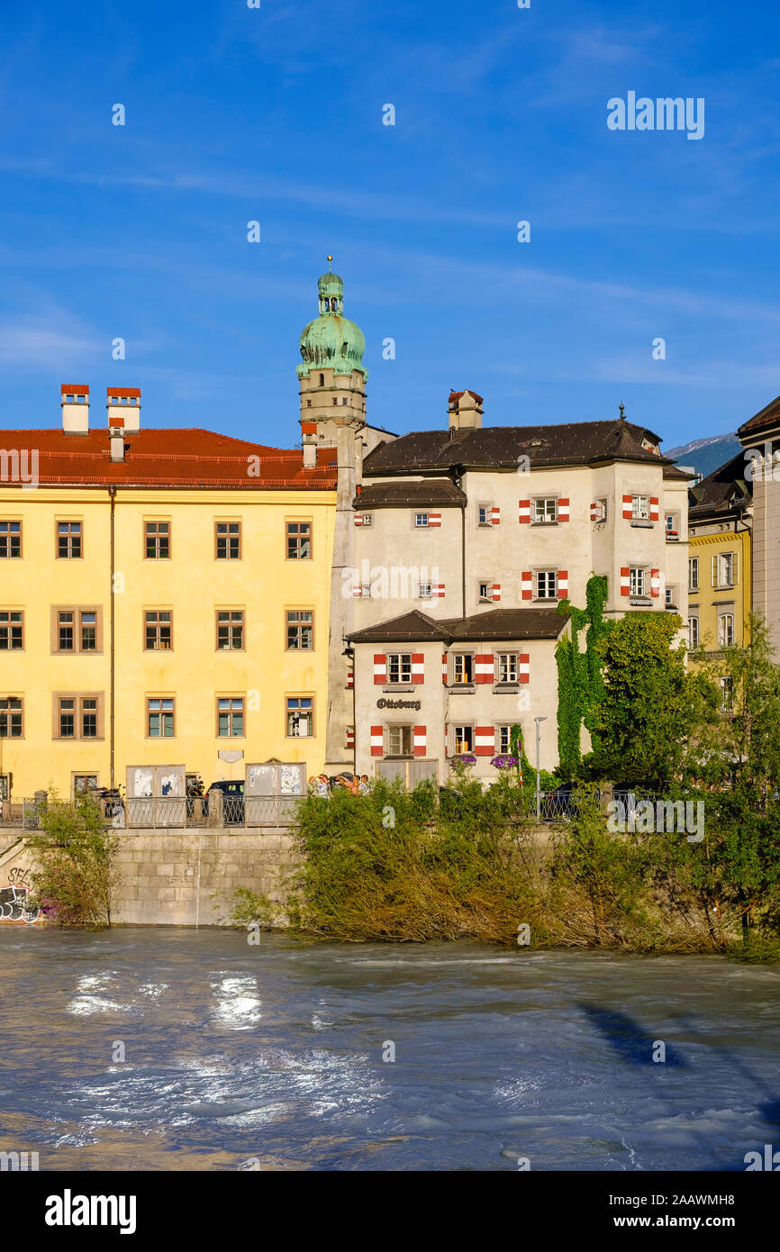 Exterior of inn and Stadtturm against blue sky at Innsbruck, Austria ...