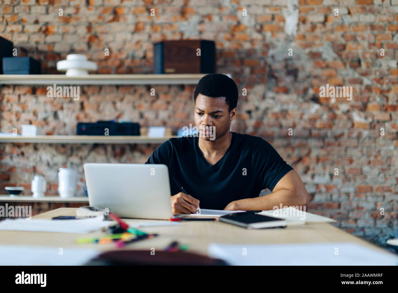 Young black man taking notes hi-res stock photography and images - Alamy