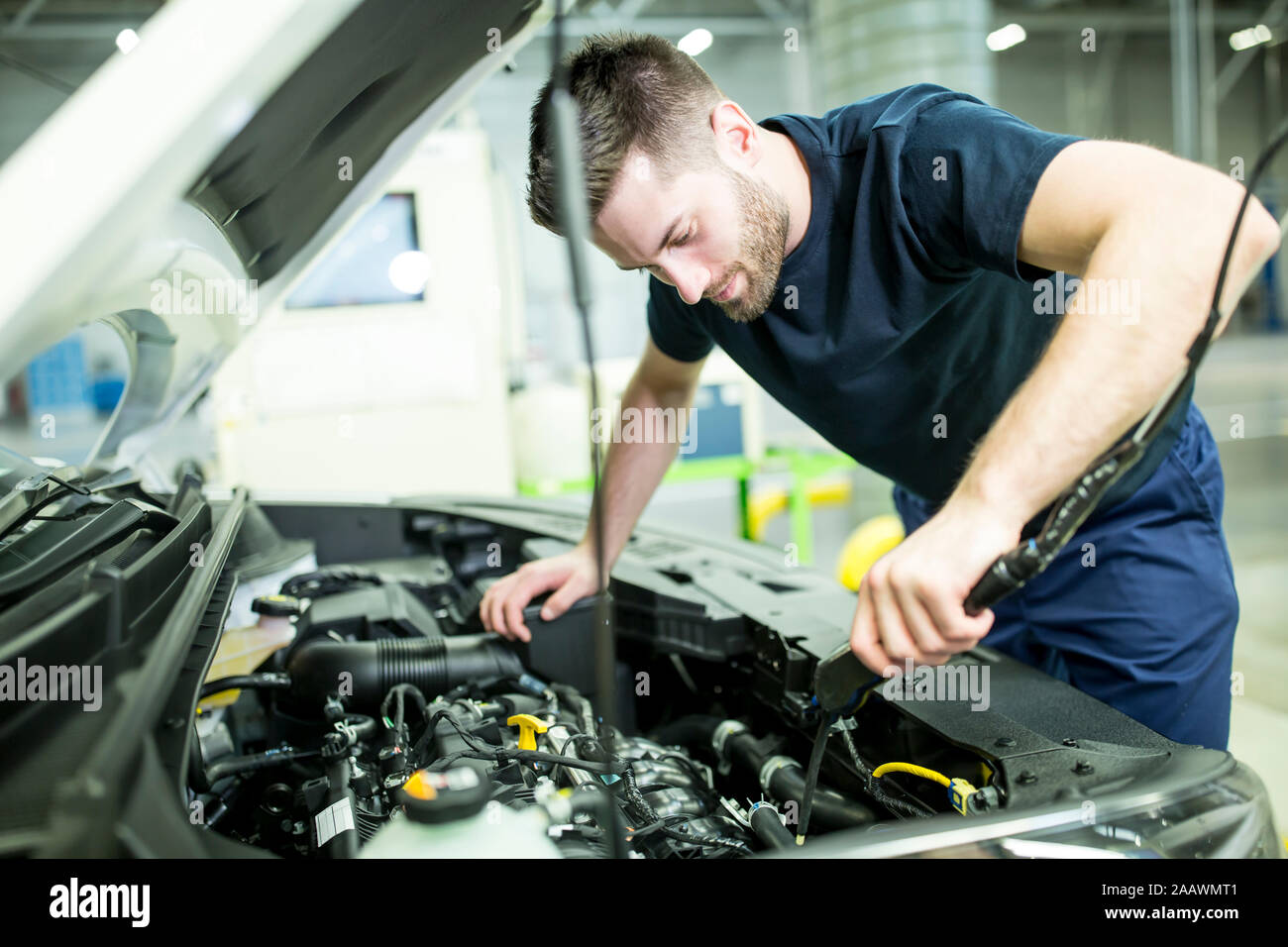 Man working on car in modern factory Stock Photo - Alamy
