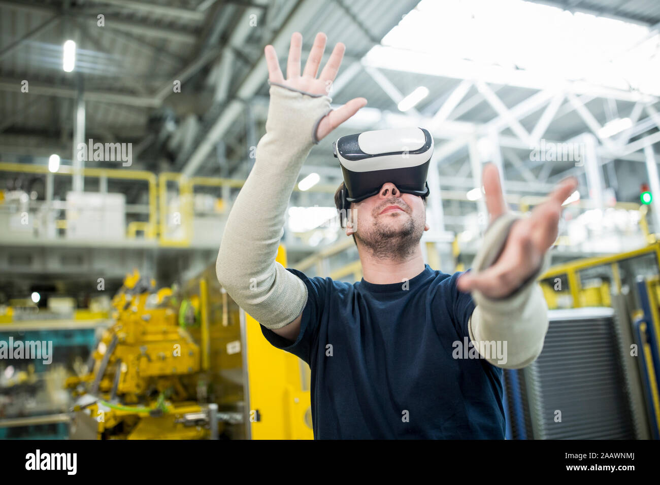 Man wearing VR glasses in modern factory Stock Photo - Alamy
