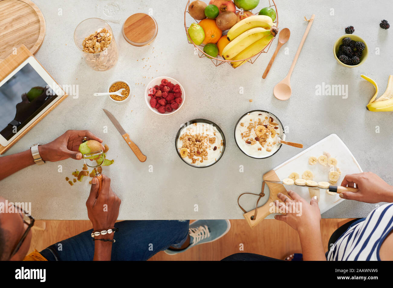 Multiethnic couple breakfasting together in the kitchen Stock Photo - Alamy
