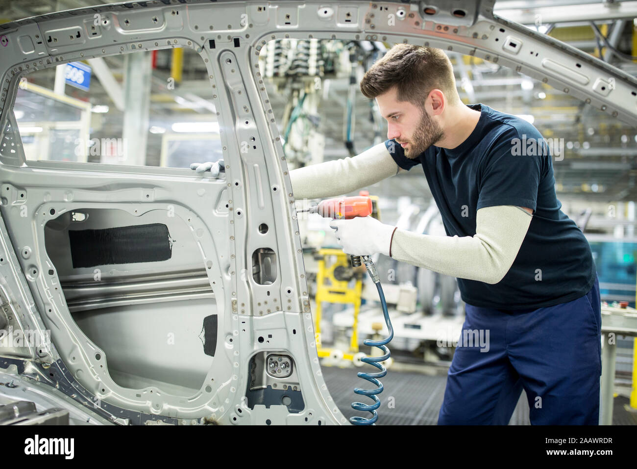 Man working in modern car factory Stock Photo - Alamy