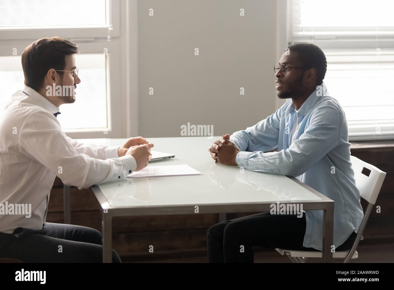 Caucasian recruiter having interview with biracial male candidate Stock ...