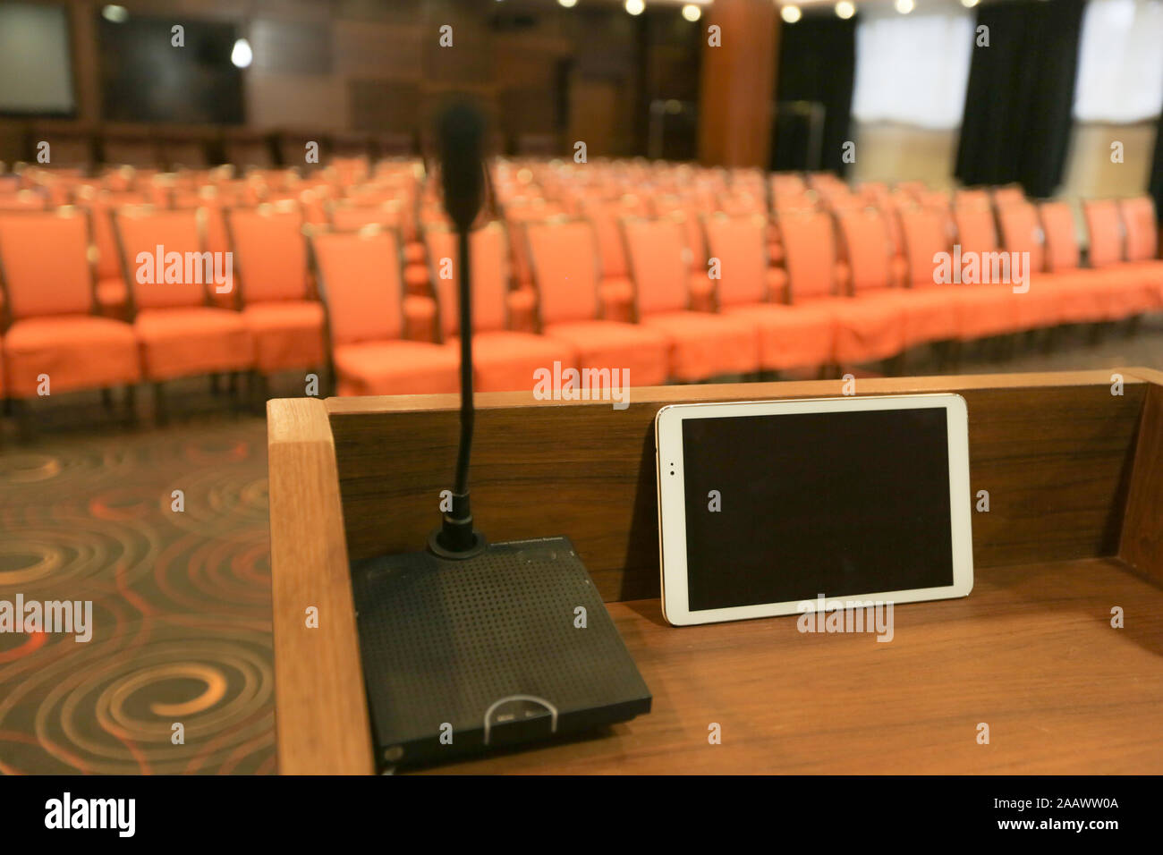 Rostrum with microphone and ipad in conference hall Stock Photo - Alamy