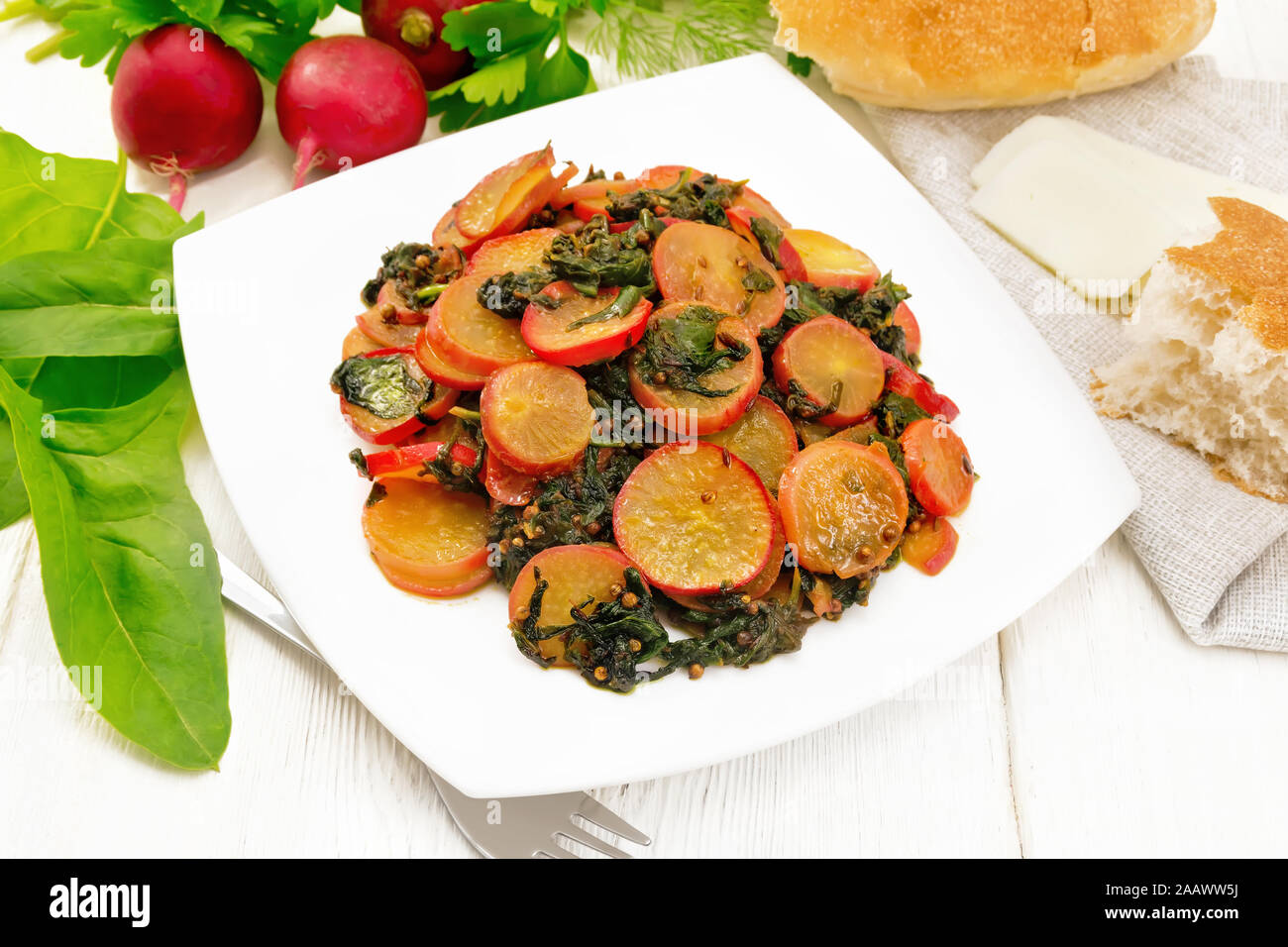 Radish stewed with spinach and spices in a plate, cheese and bread ...
