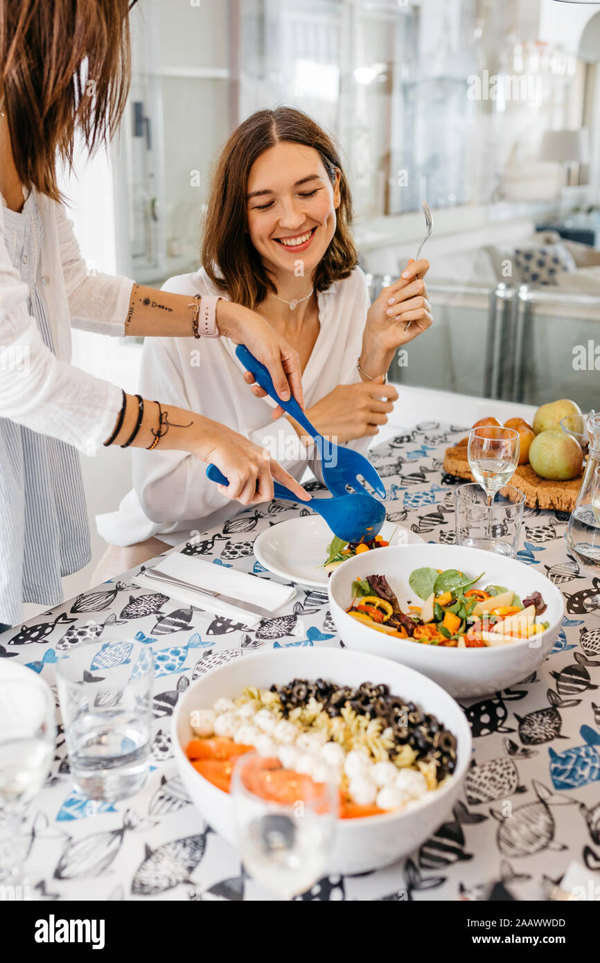 Happy friends having healthy lunch together Stock Photo - Alamy