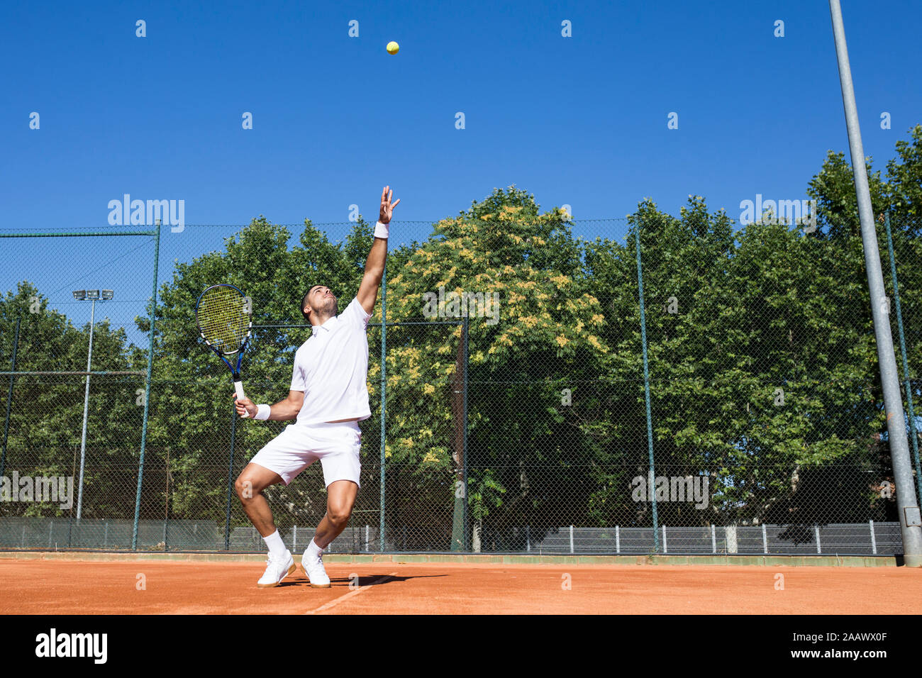 Tennis player serving a tennis ball during a tennis match Stock Photo ...
