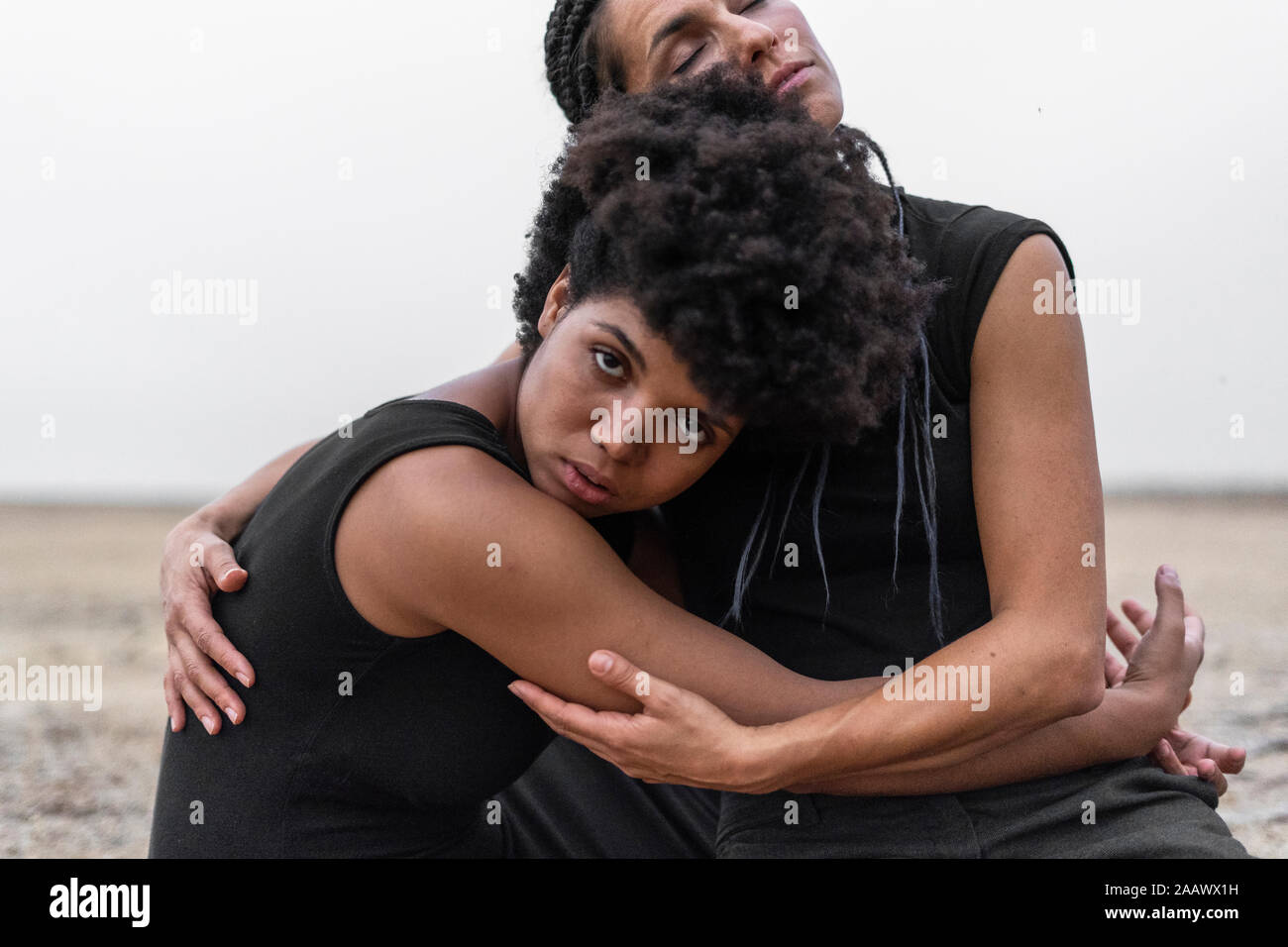 Two black women hugging each other hi-res stock photography and images ...